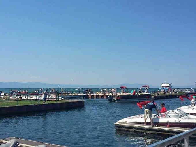 The marina bustles with activity as boats prepare for adventures on America's purest alpine lake.
