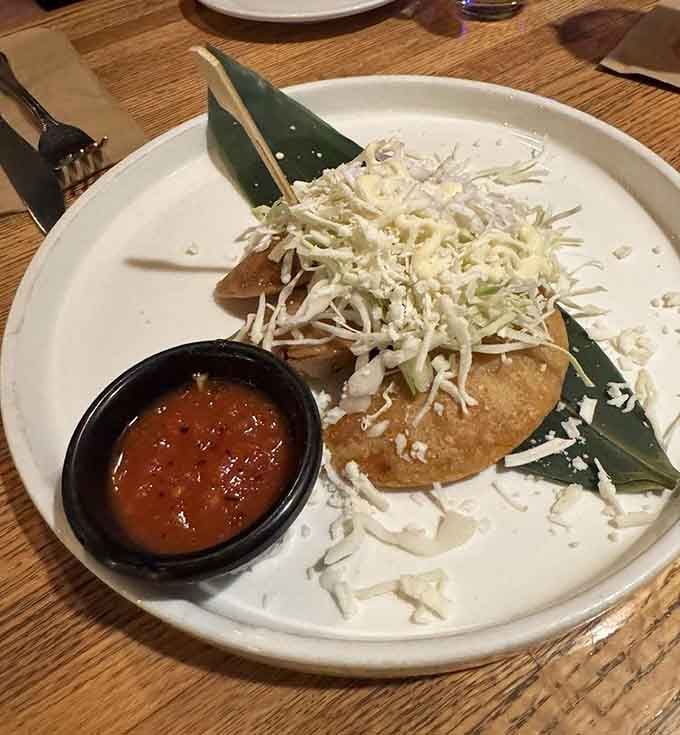 Crispy golden empanadas with fresh cabbage slaw prove that simple preparations often yield the most satisfying results.