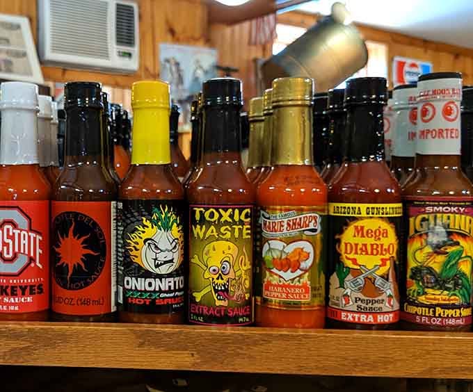 Hot sauce bottles promise adventure for brave souls seeking flavors that'll wake up every sleeping taste bud.