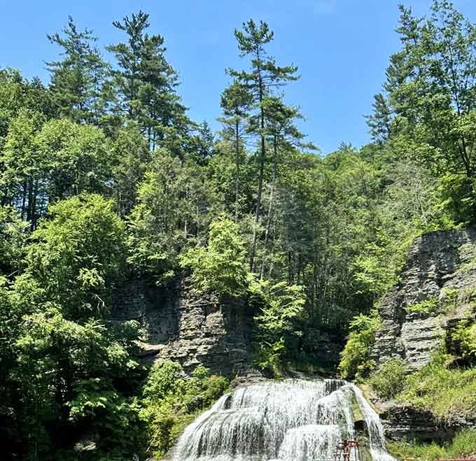 Lush greenery frames the cascading water, creating a postcard scene that somehow exists in real life, not fantasy.