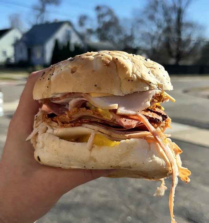 The Monster earns its name with layers of turkey, chicken, corned beef, and pastrami defying basic sandwich physics.