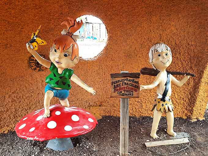 Pebbles and Bamm-Bamm frozen mid-play, forever young in their colorful Stone Age playground of eternal childhood.