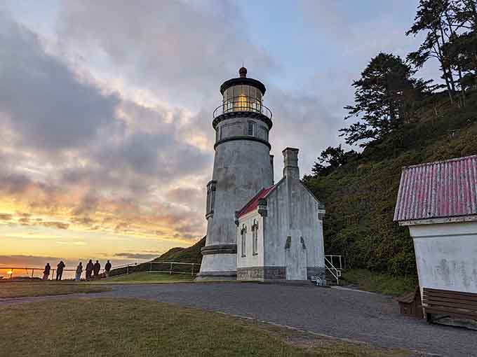 Heceta Head Lighthouse glows at sunset, standing sentinel over the coast like a postcard come to life.