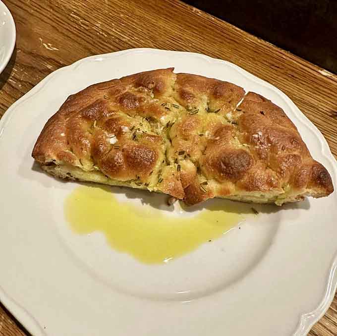 Golden focaccia that's basically edible architecture, proving bread can be both simple and absolutely show-stopping at once.