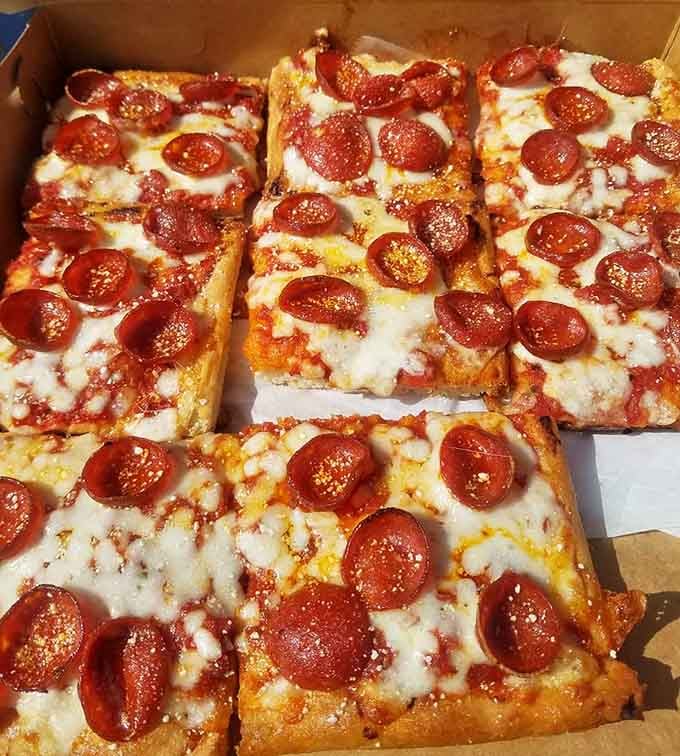 Those pepperoni cups curling up at the edges are basically little pools of spicy, greasy joy on every slice.