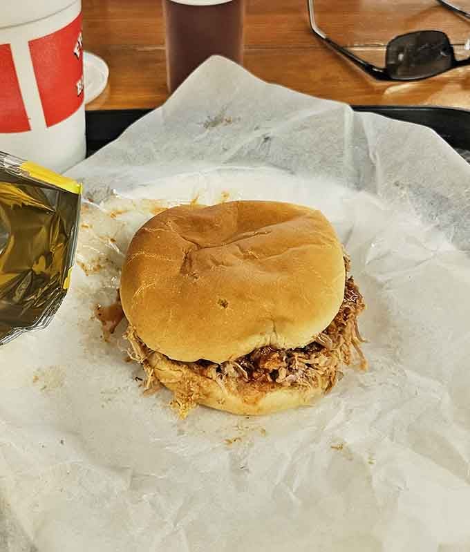 A chopped pork sandwich on a soft bun, proving that sometimes the most straightforward approach yields the most satisfying results.