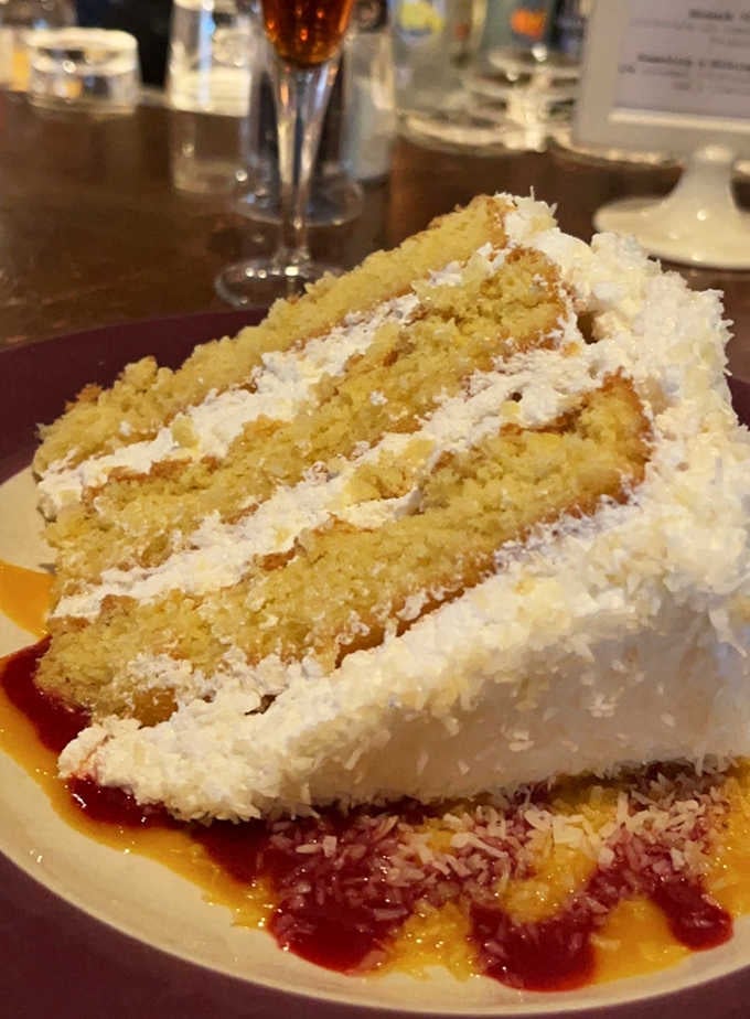 That towering coconut cake slice represents everything right about homemade desserts, pure heaven on a plate.