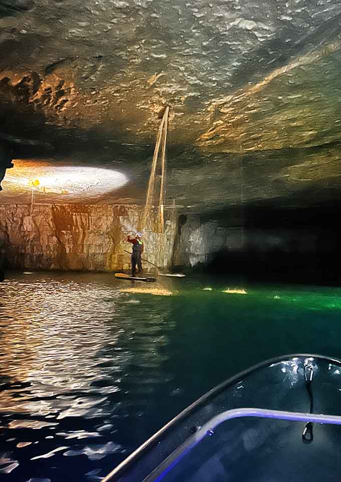 Stand-up paddleboarding in a limestone mine, because apparently someone asked "why not?" and actually meant it.
