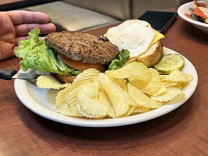 A burger so juicy it requires strategic napkin placement and possibly a change of shirt afterward.