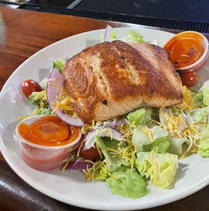 Perfectly seasoned salmon atop fresh greens shows that healthy eating doesn't require sacrificing flavor or satisfaction.
