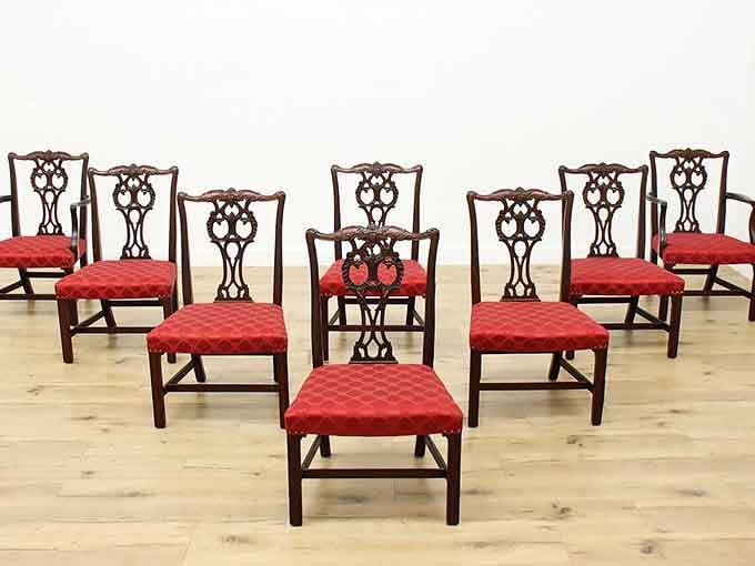 Eight Chippendale-style dining chairs with rich red upholstery, because your dinner guests deserve better seating.