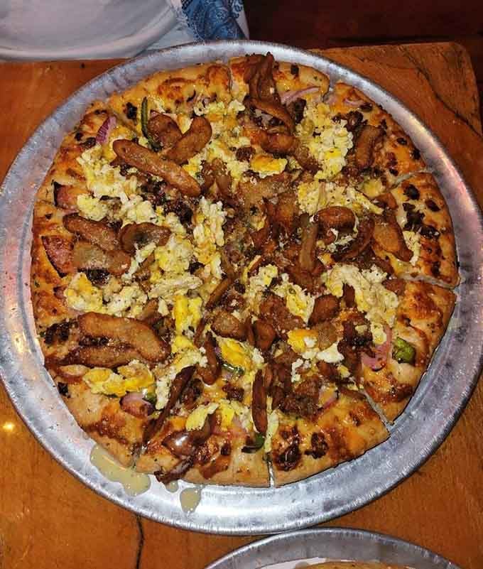 Breakfast pizza topped with what appears to be potato chips, because why should morning foods have all the fun?