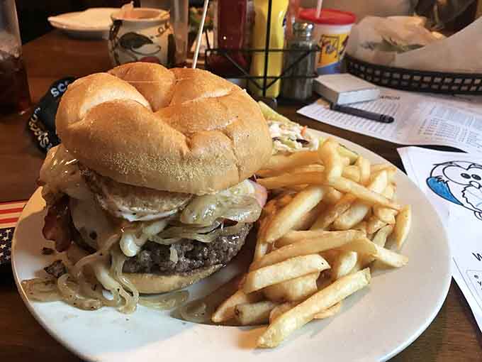 The Tavern Burger towers like a delicious skyscraper, making you wonder if you need an engineering degree to eat it.