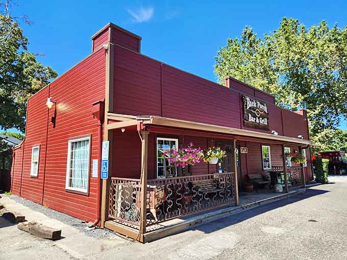 The Back Porch Bar & Grill wears its red paint proudly, standing out like the friend who always knows how to have fun.
