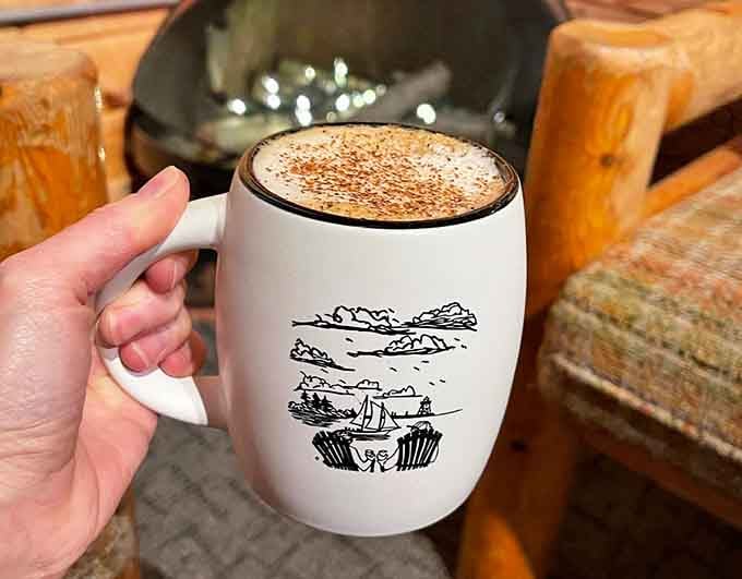 This latte comes with its own scenic illustration, because even the mugs understand the assignment here.