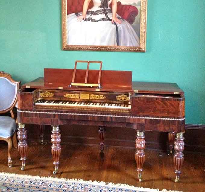 An authentic period piano sits ready to fill these historic rooms with melodies from a more elegant time.