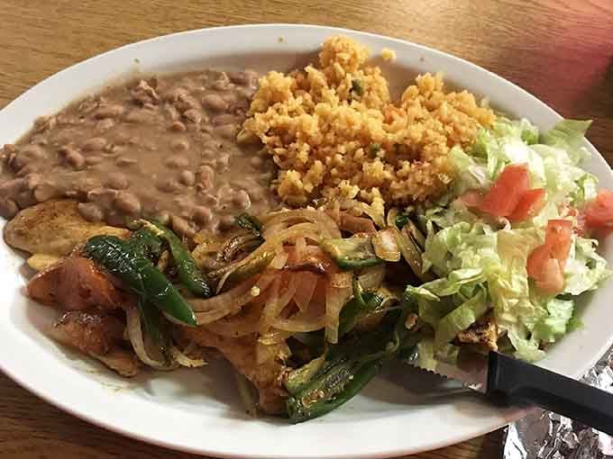 Sizzling chicken fajitas arrive with peppers and onions, bringing the kind of drama your taste buds have been craving.