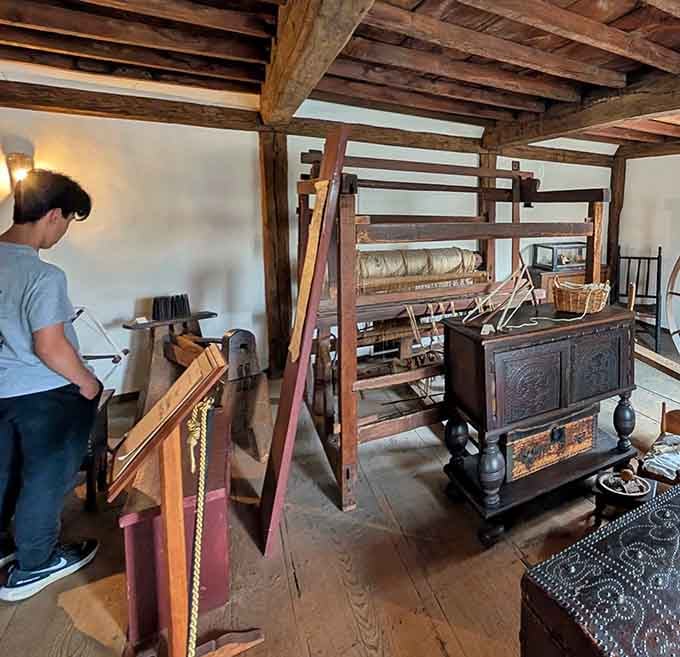 Modern visitors contemplate a spinning wheel, grateful they can buy clothes without operating medieval machinery.