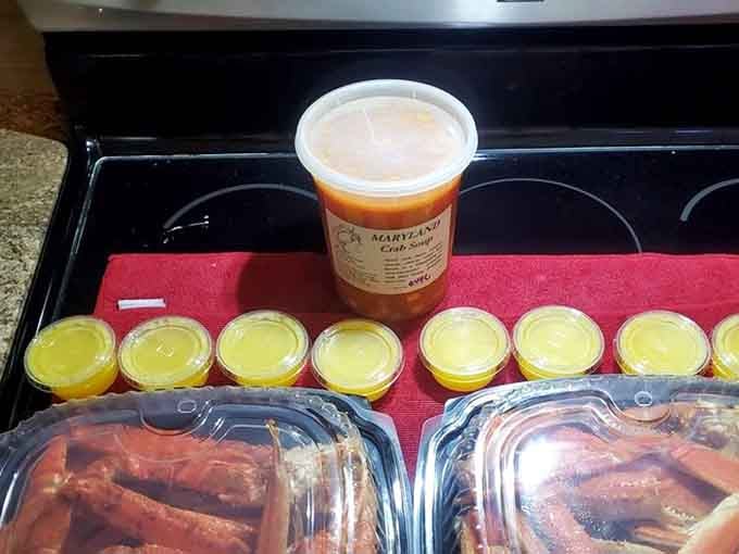That container of crab soup flanked by melted butter cups is basically a hug in edible form for your soul.