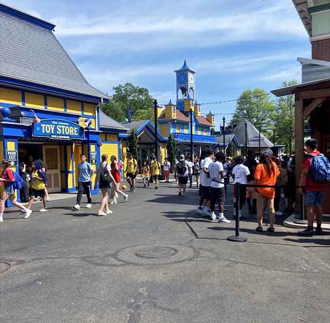 The main street buzzes with energy as families explore shops and plan their next adrenaline-fueled adventure.