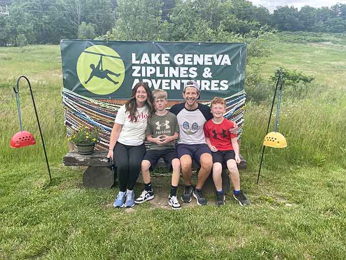 Mission accomplished! This family conquered the courses and earned their spot in front of the banner.