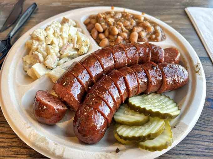 Perfectly smoked sausage with beans and slaw demonstrates why sides matter almost as much as the star.
