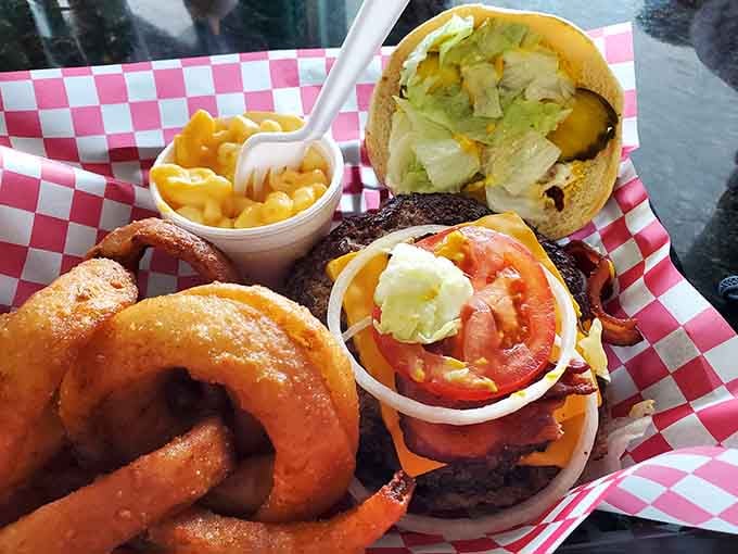 This bacon cheeseburger brings friends: creamy mac and cheese plus golden onion rings that deserve their own fan club.