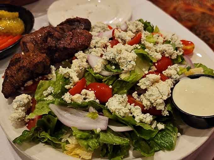 Blue cheese crumbles cascade over blackened beef tips like delicious snow on a very meaty mountain.