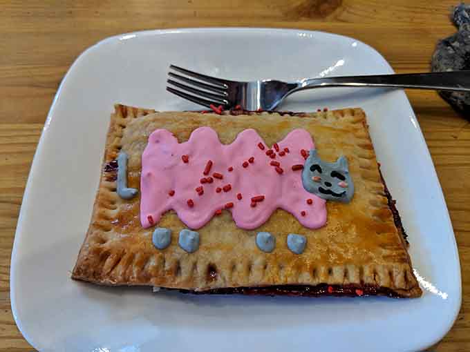 That pink frosting spells "MEOW" louder than any cat in the building, and yes, it tastes as delightful as it looks.