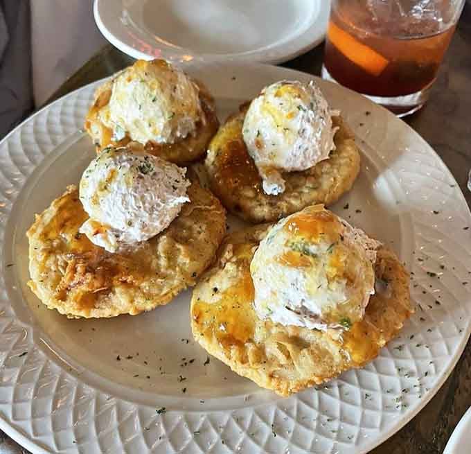 Fried green tomatoes topped with what appears to be heaven in cream cheese form, proving Southern cooking is pure genius.