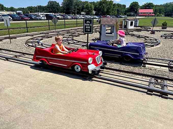 Vintage kiddie cars circling their track like a miniature Indy 500, complete with drivers who haven't discovered power steering yet.