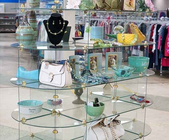 Glass shelves displaying handbags and jewelry like tiny museums of someone's former fabulous life, now yours for pennies.