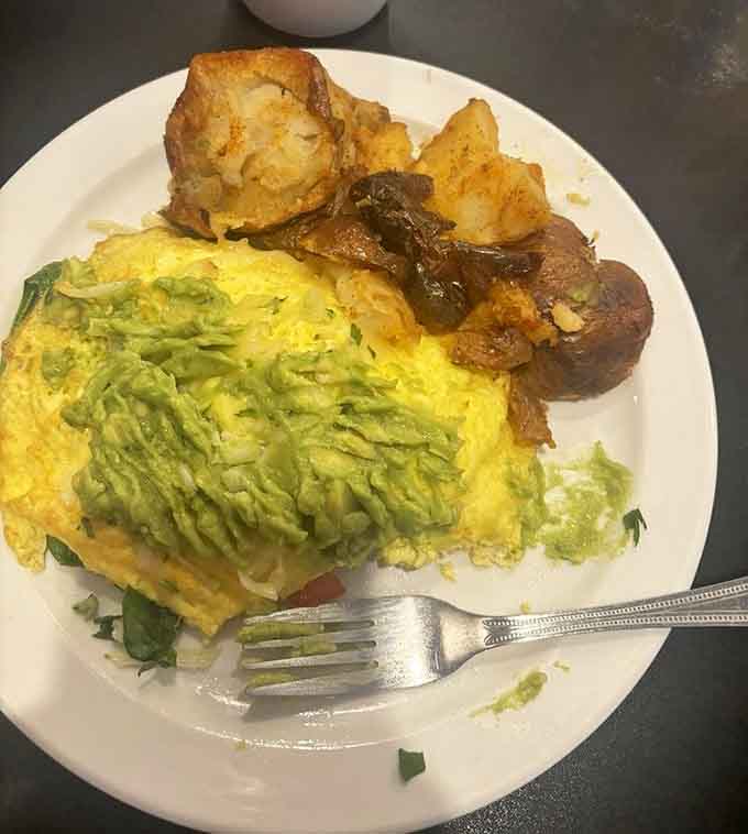 This omelet arrives loaded with avocado and perfectly cooked eggs that respect the craft of breakfast making.