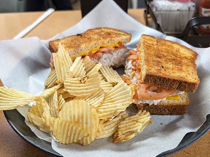 A tuna melt on toasted bread with a pile of ridged chips. Lunch doesn't need to be complicated.
