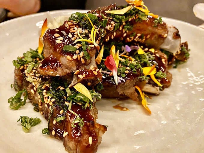 Sticky ribs glazed to glistening perfection with sesame seeds and fresh herbs that'll have you licking your fingers shamelessly.