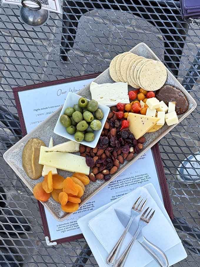 Cheese, crackers, and colorful accompaniments arranged with the kind of care that makes snacking feel sophisticated.
