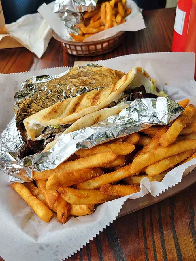 That gyro wrapped in foil with a mountain of fries is basically a love letter to your appetite.