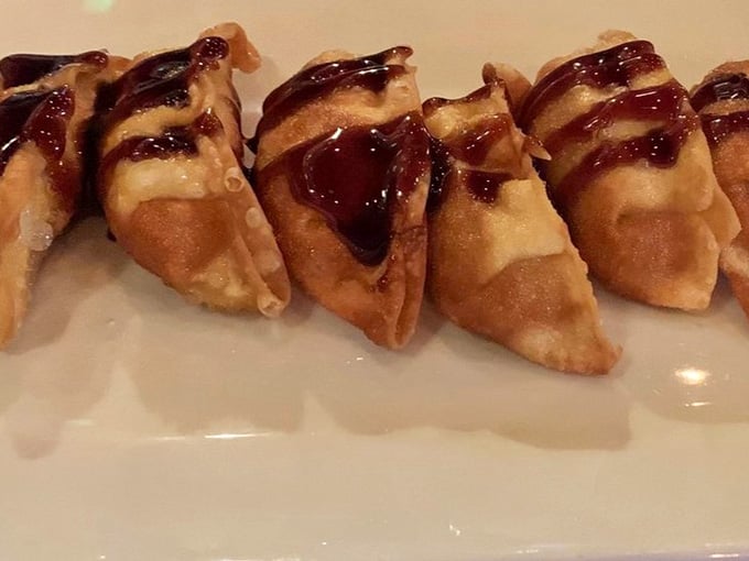 Golden gyoza lined up like little soldiers, each one crispy-bottomed and ready to deliver savory satisfaction with every bite.