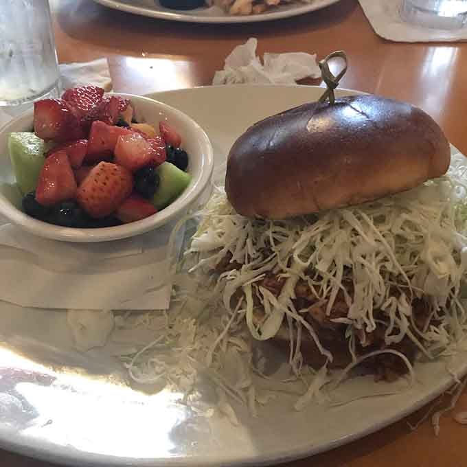Fresh fruit on the side means you can pretend this meal is healthy before diving into that glorious sandwich situation.