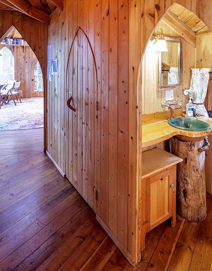 Even the bathroom vanity gets the organic treatment with what appears to be an actual tree trunk as the base.