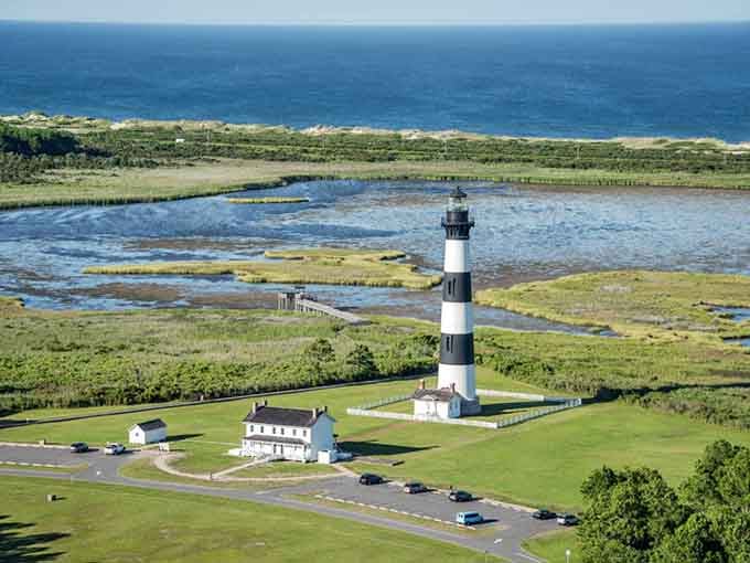 Bodie Island Lighthouse stands sentinel over marshlands where land and water can't quite decide where one ends.
