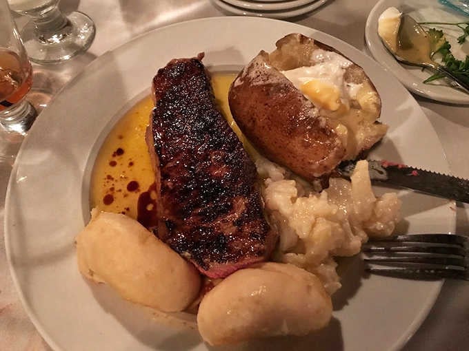 Medium-rare New York strip showcasing that perfect pink center and robust flavor that needs zero embellishment.