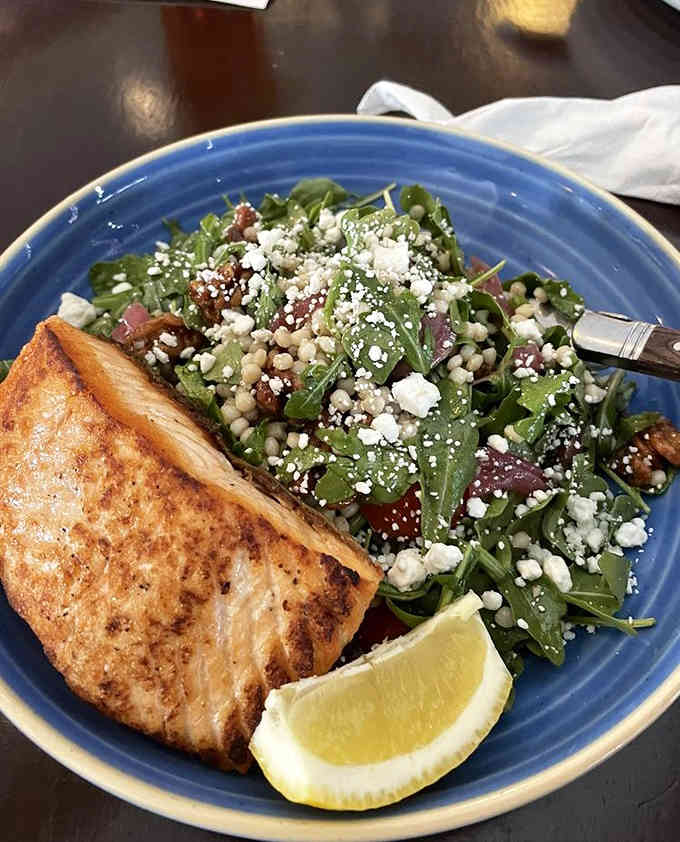 Grilled salmon paired with a vibrant salad, because not every meal requires gravy and carbs, surprisingly enough.
