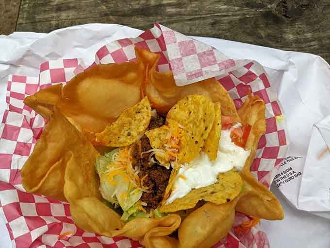 This taco salad in a crispy shell understands that presentation matters, even when you're eating with your hands.