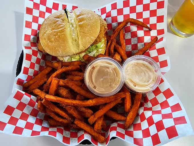 Golden fried chicken nestled in a bun with sweet potato fries that could convert any regular fry loyalist.