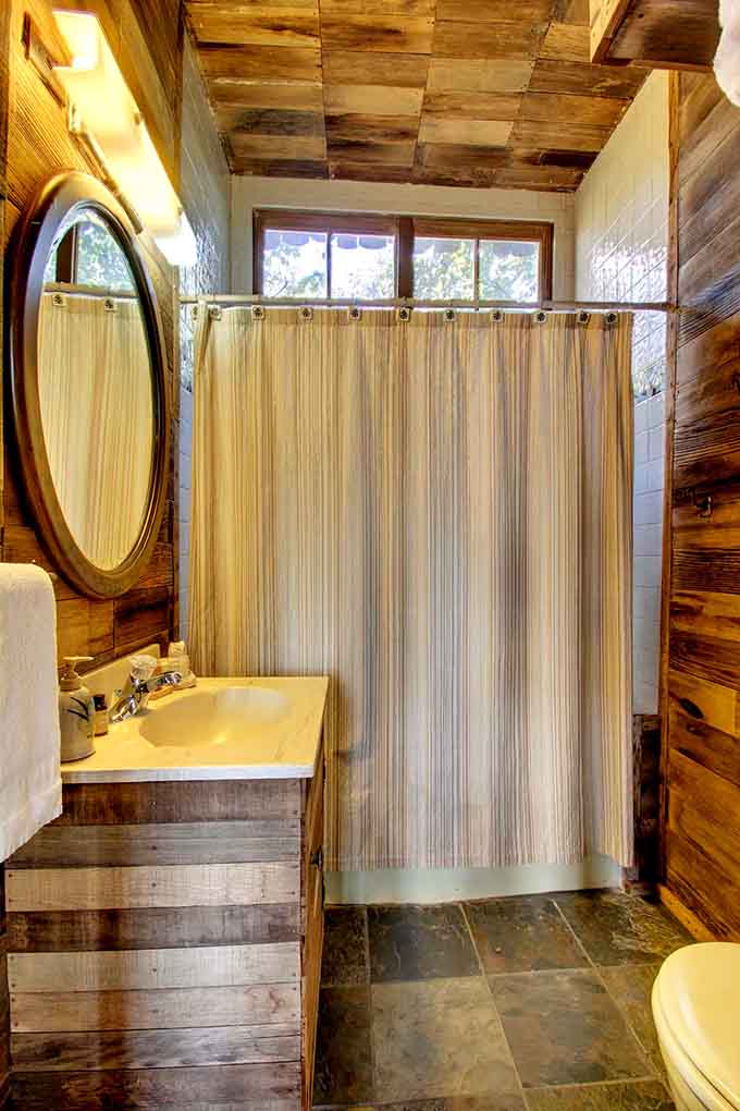 Even the bathroom maintains that rustic charm, proving you don't sacrifice style when living among the trees.