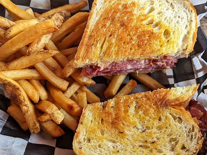The Reuben arrives golden and griddled, stacked with corned beef that would make your grandmother weep with joy.