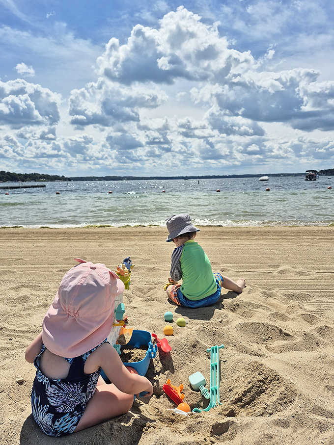 Kids building sandcastles while clouds paint masterpieces overhead; summer multitasking at its finest.