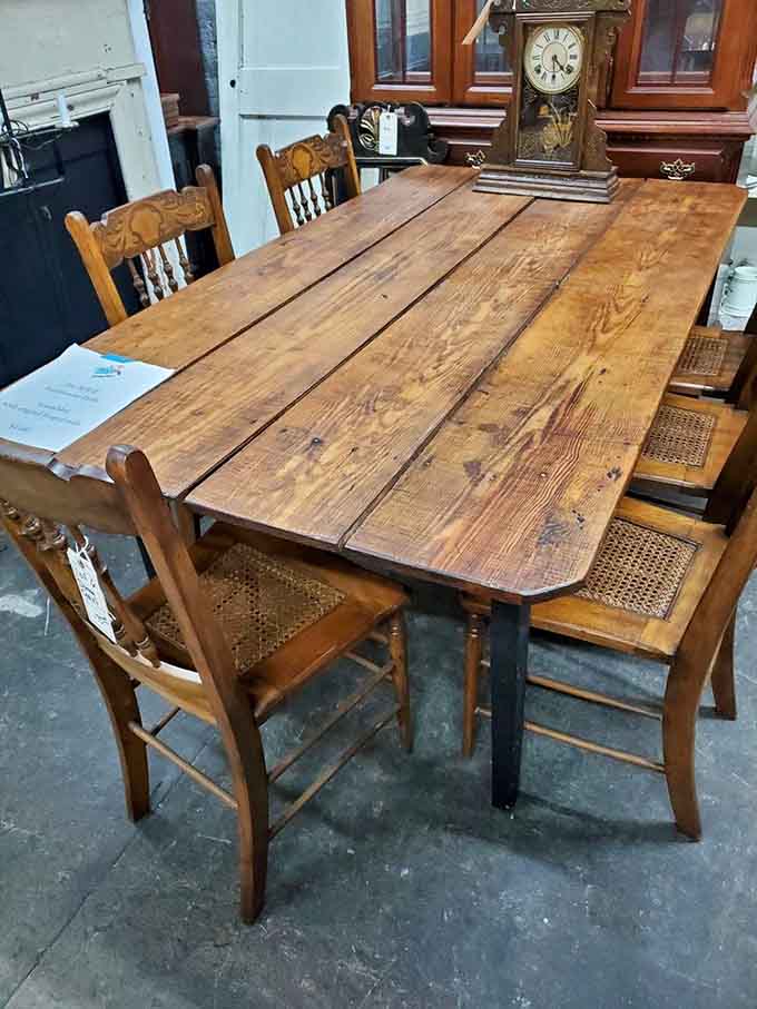 A solid farmhouse table with character-rich wood grain waits to host countless future family dinners and game nights.