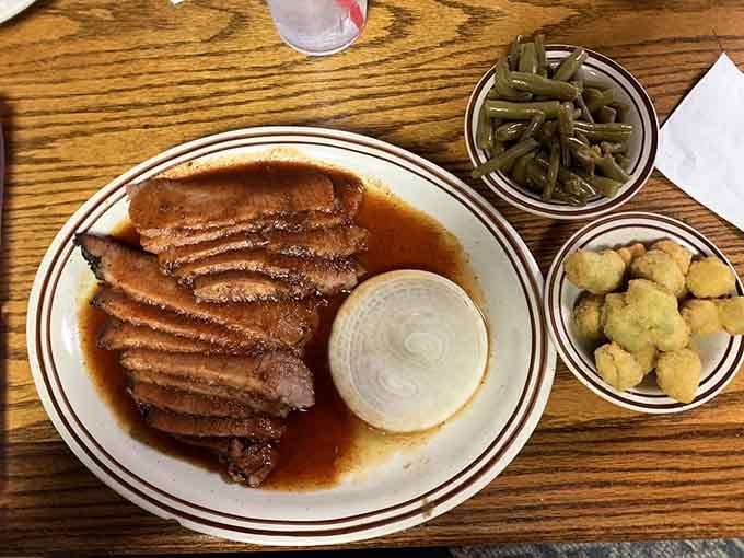 Sliced brisket swimming in gravy with sides that prove Texas knows exactly what it's doing.